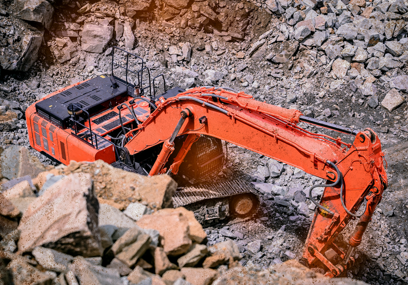 Excavator picking up rocks living room wall mural - TenStickers